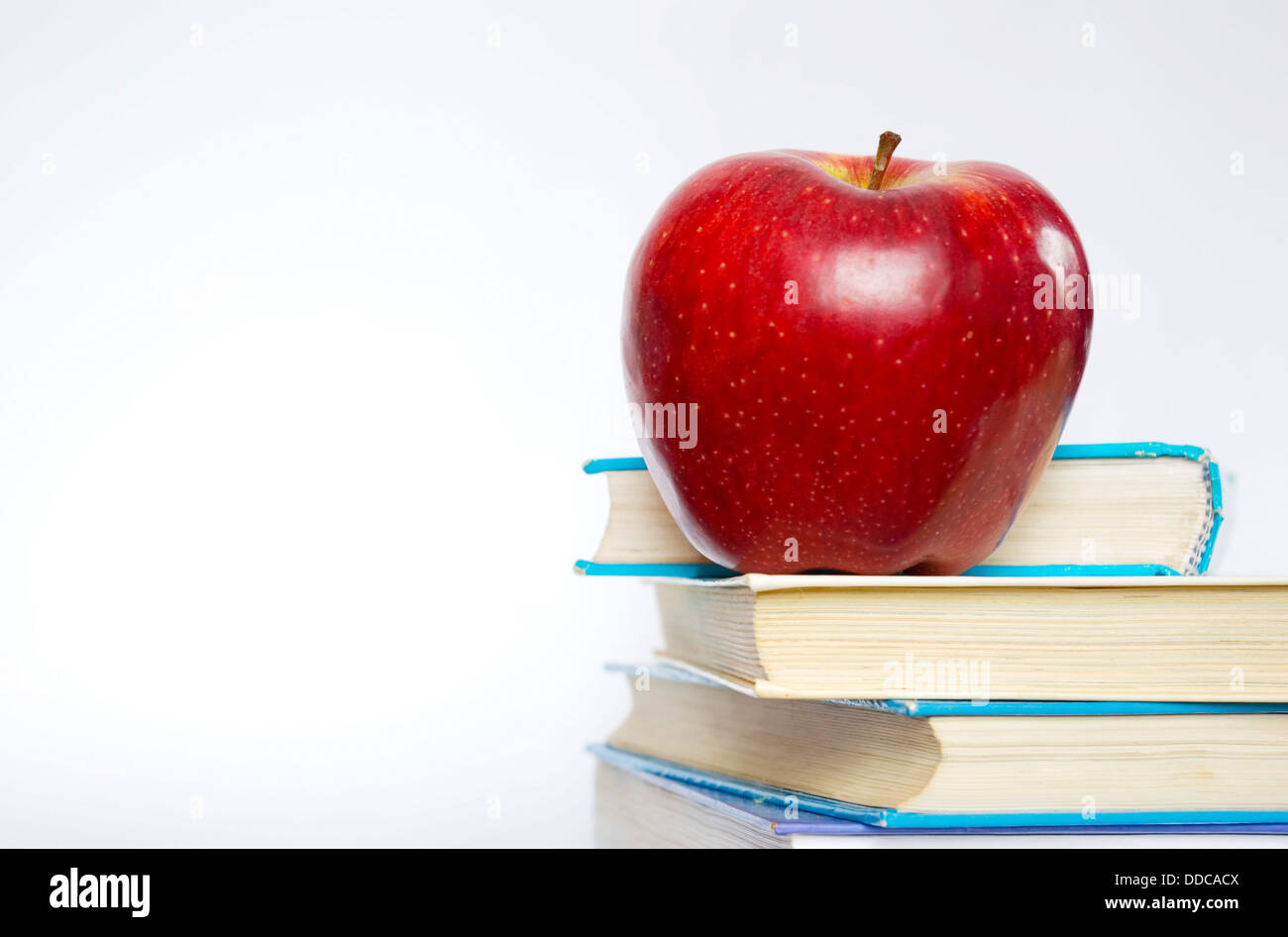 apple on books Stock Photo - Alamy