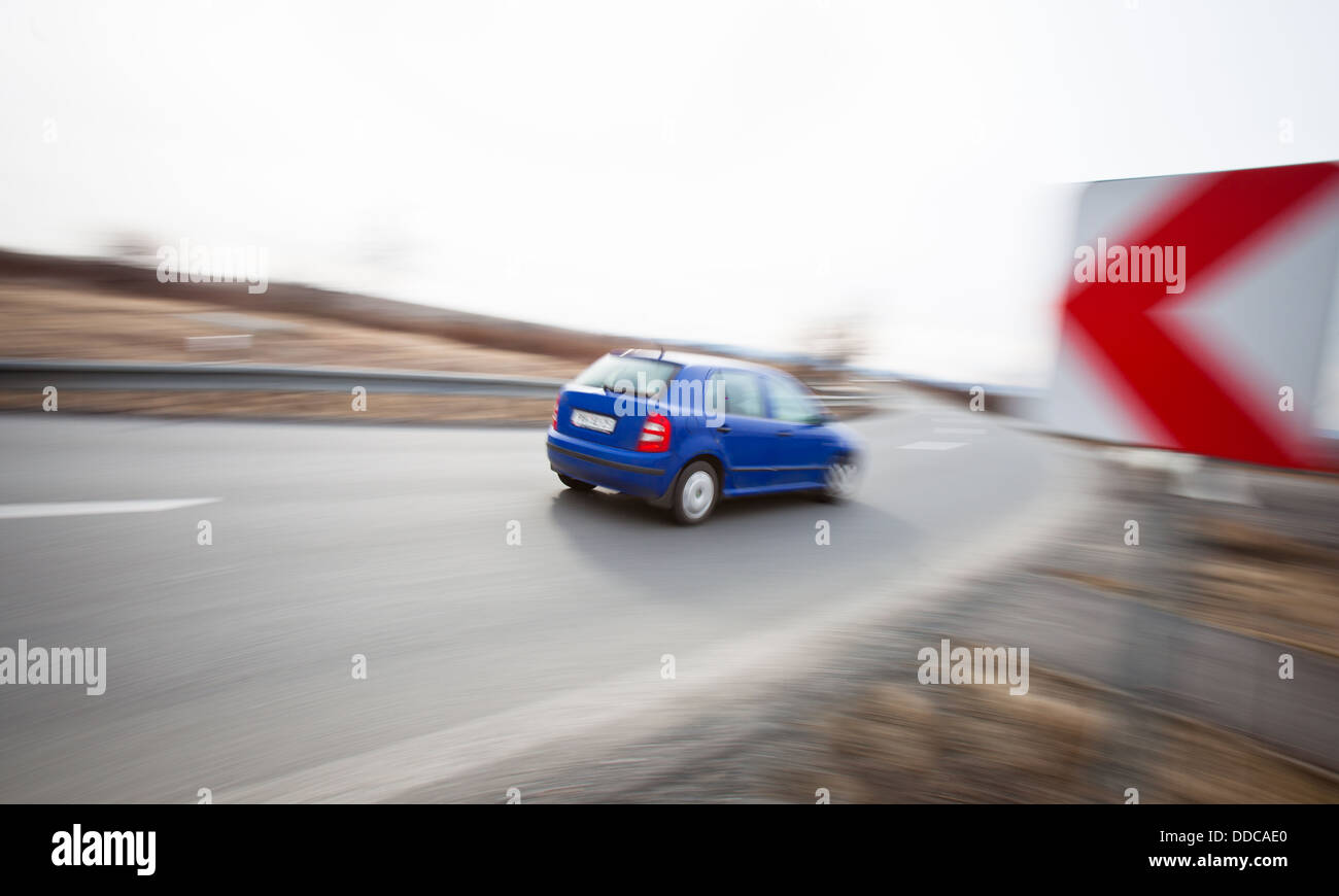 Traffic concept: car driving fast through a sharp turn Stock Photo - Alamy