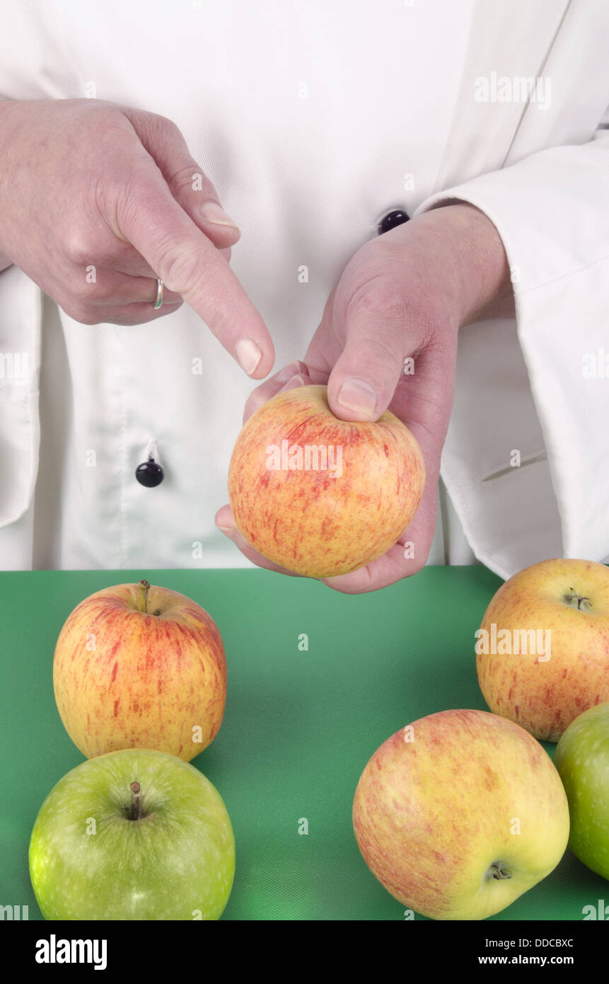 female chef shows with her index finger on an apple Stock Photo - Alamy