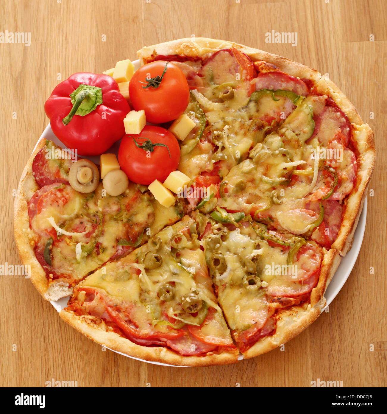 Fresh italian pizza in plate on a wooden surface Stock Photo - Alamy