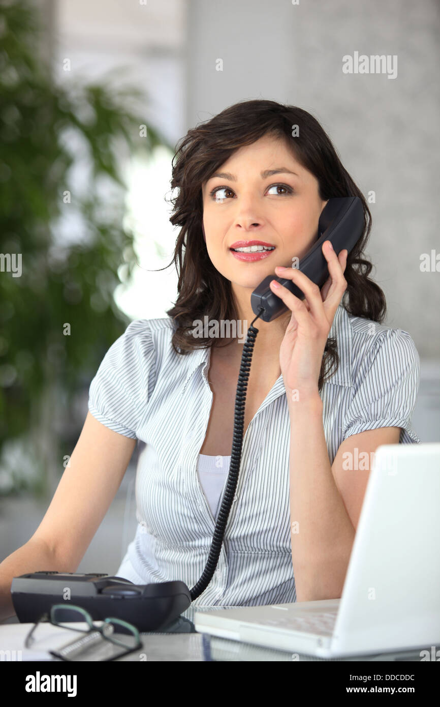 Receptionist answering the telephone Stock Photo - Alamy