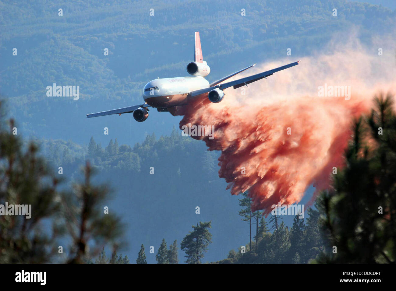 A DC-10 air tanker drops chemical fire retardant below Pilot Peak at ...
