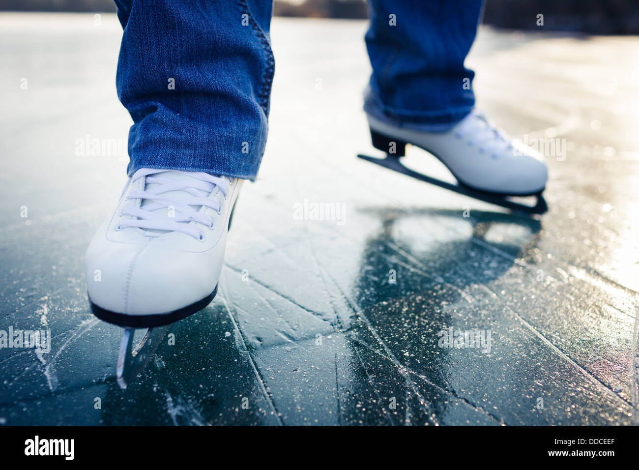Young woman ice skating outdoors on a pond Stock Photo - Alamy