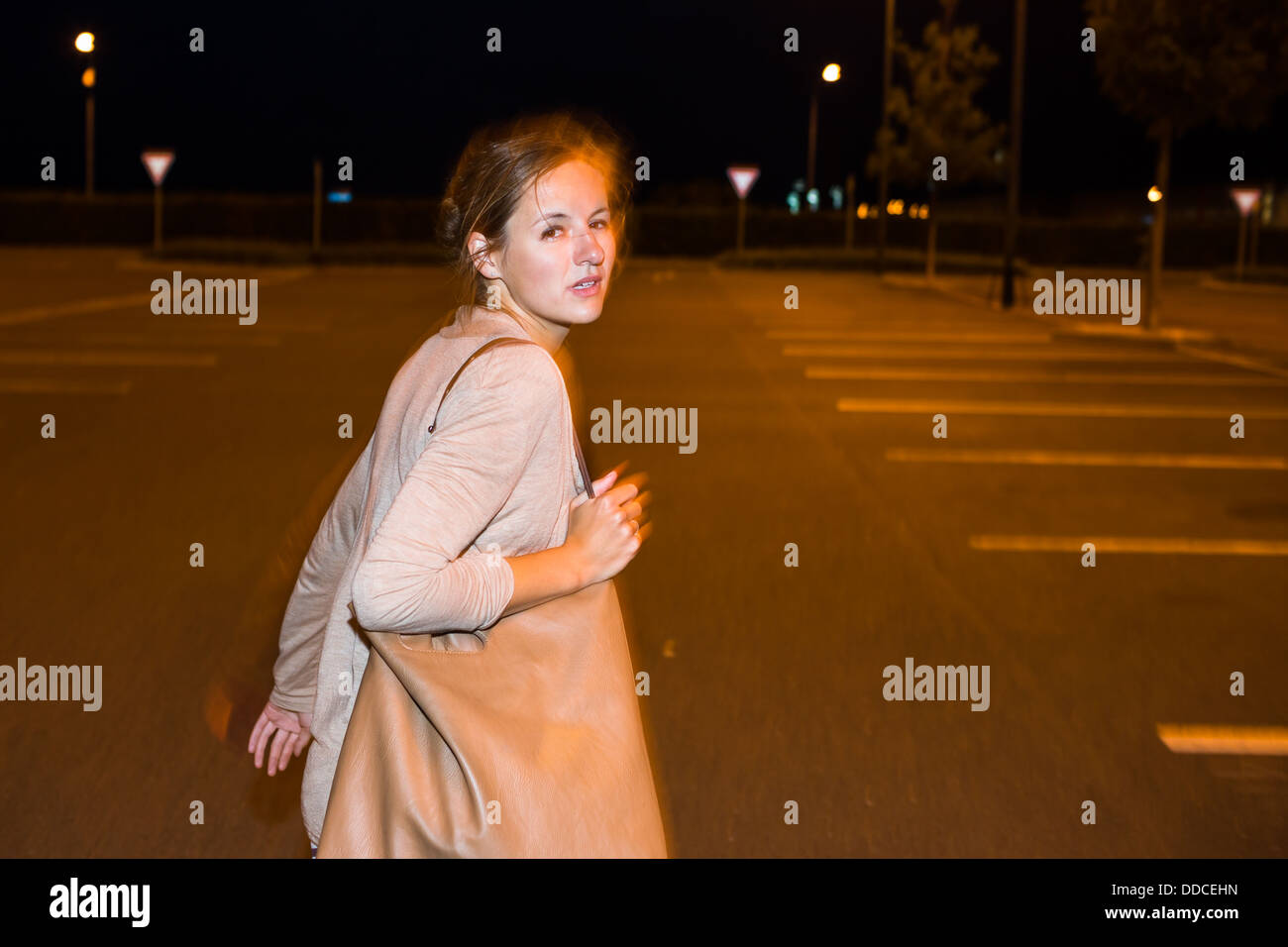 Scared young woman running from her pursuer in a deserted parkin Stock ...