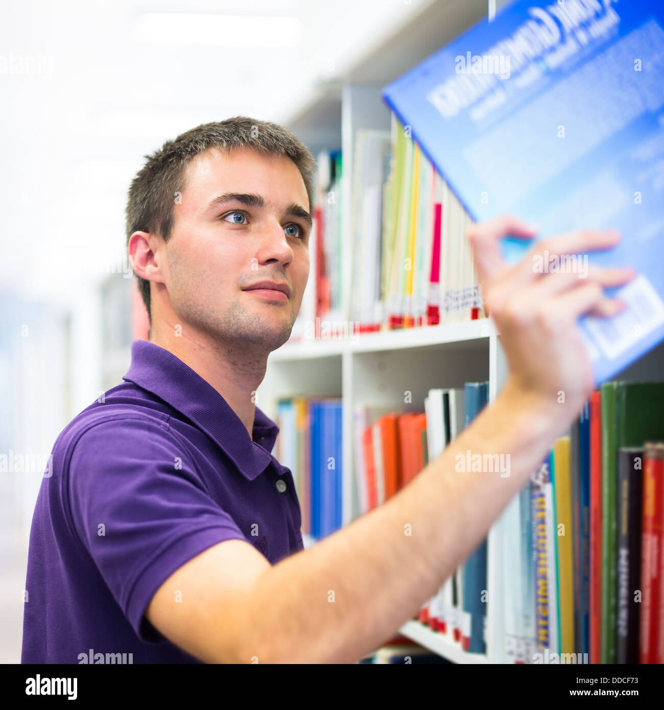 Handsome college student in library Stock Photo - Alamy