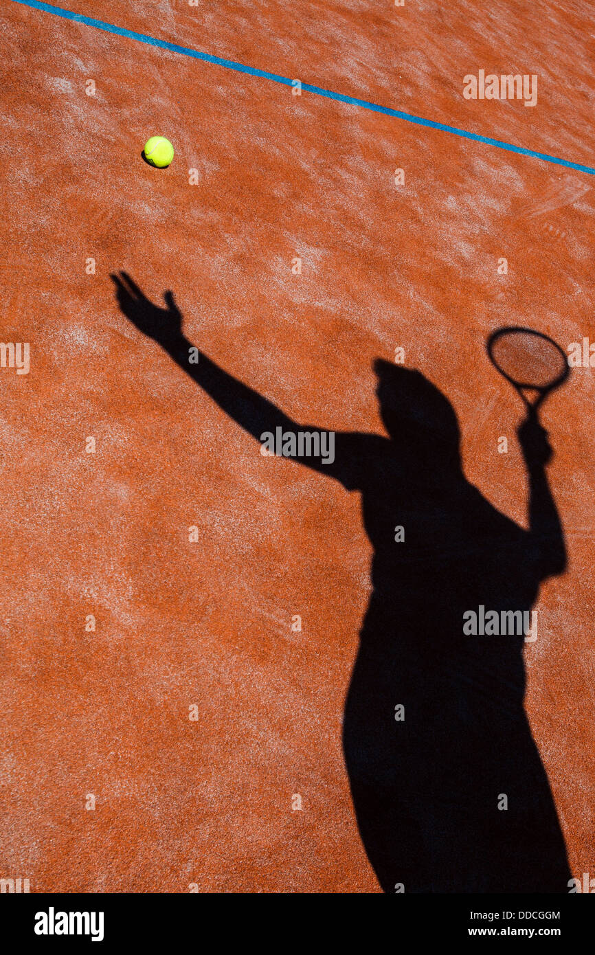 shadow of a tennis player in action on a tennis court Stock Photo - Alamy