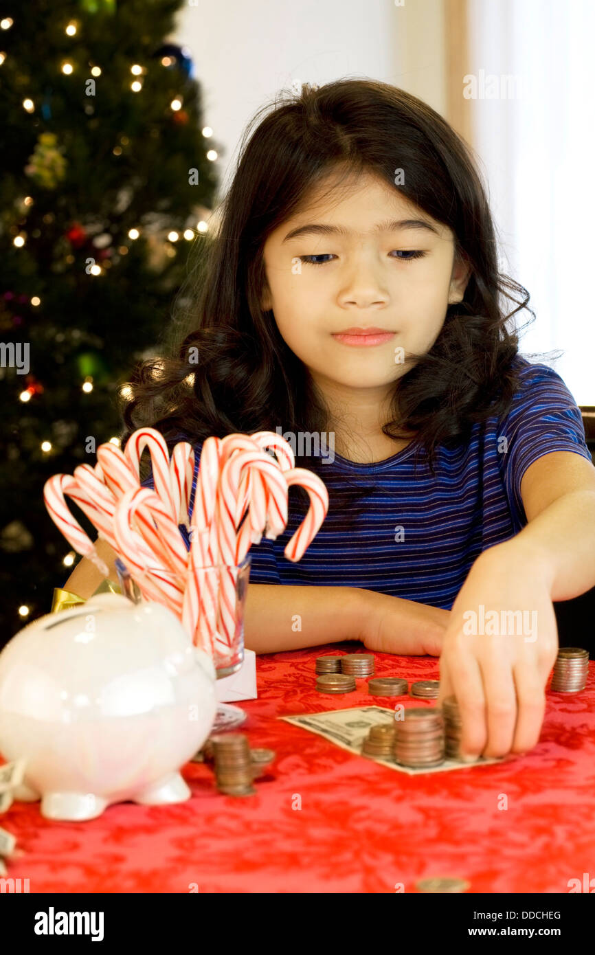 Little girl counting money at Christmas Stock Photo - Alamy