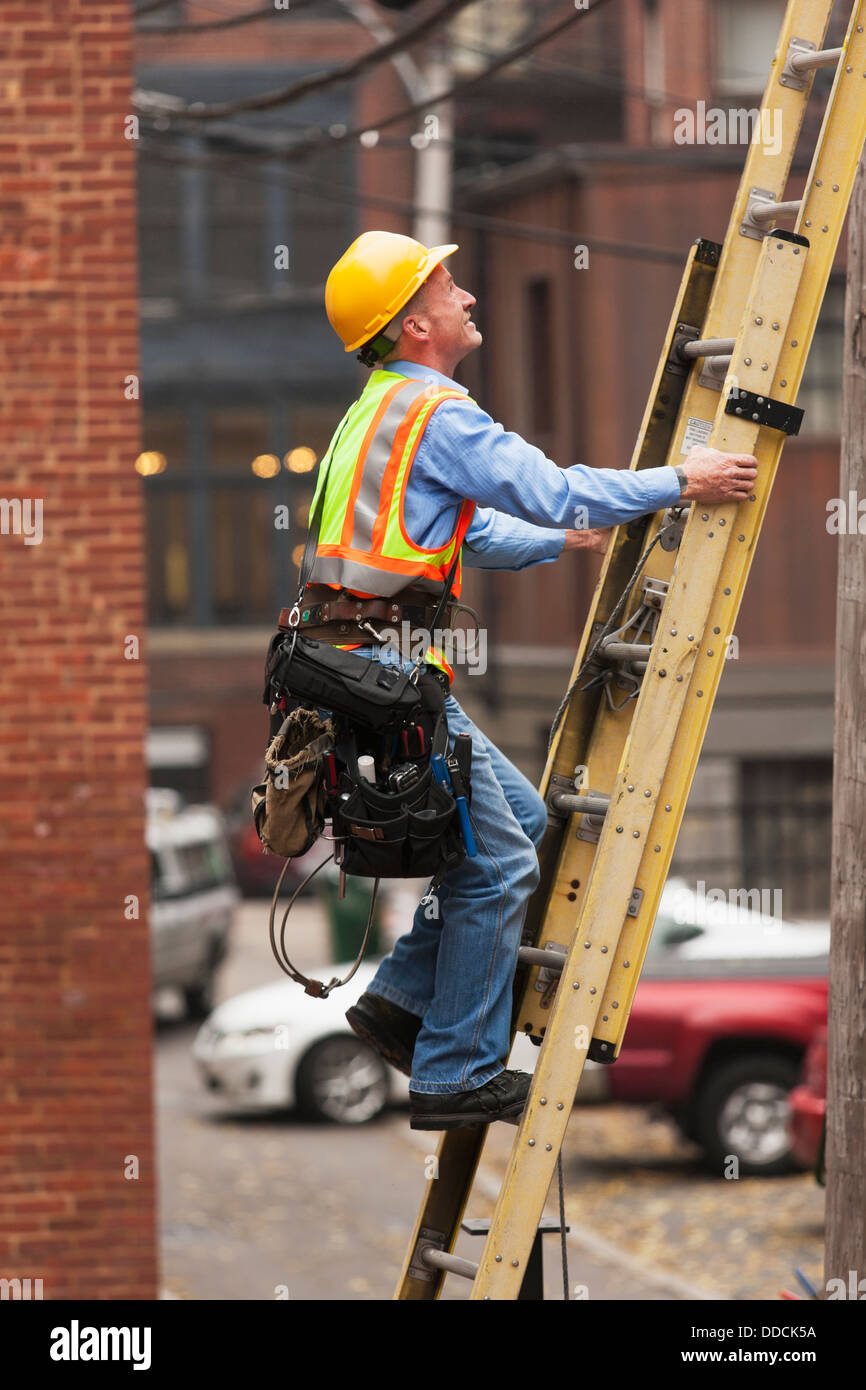 Worker Climbing Ladder