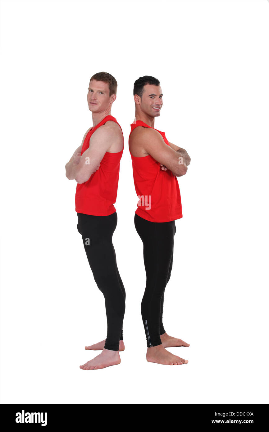 Gymnasts standing back to back Stock Photo - Alamy