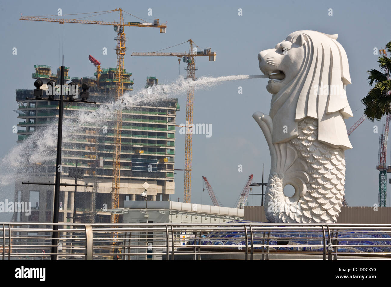 The Merlion, symbol of Singapore, in front of continuing high-rise ...