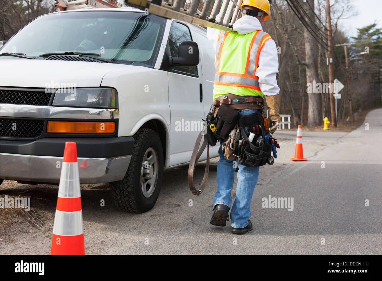 Power line worker with ladder at his truck Stock Photo - Alamy