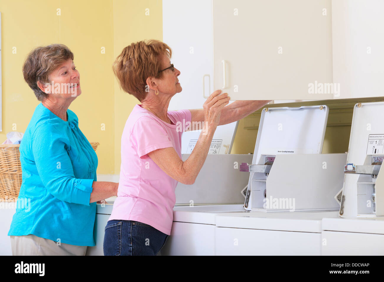 Women opening cabinet room hi-res stock photography and images - Alamy