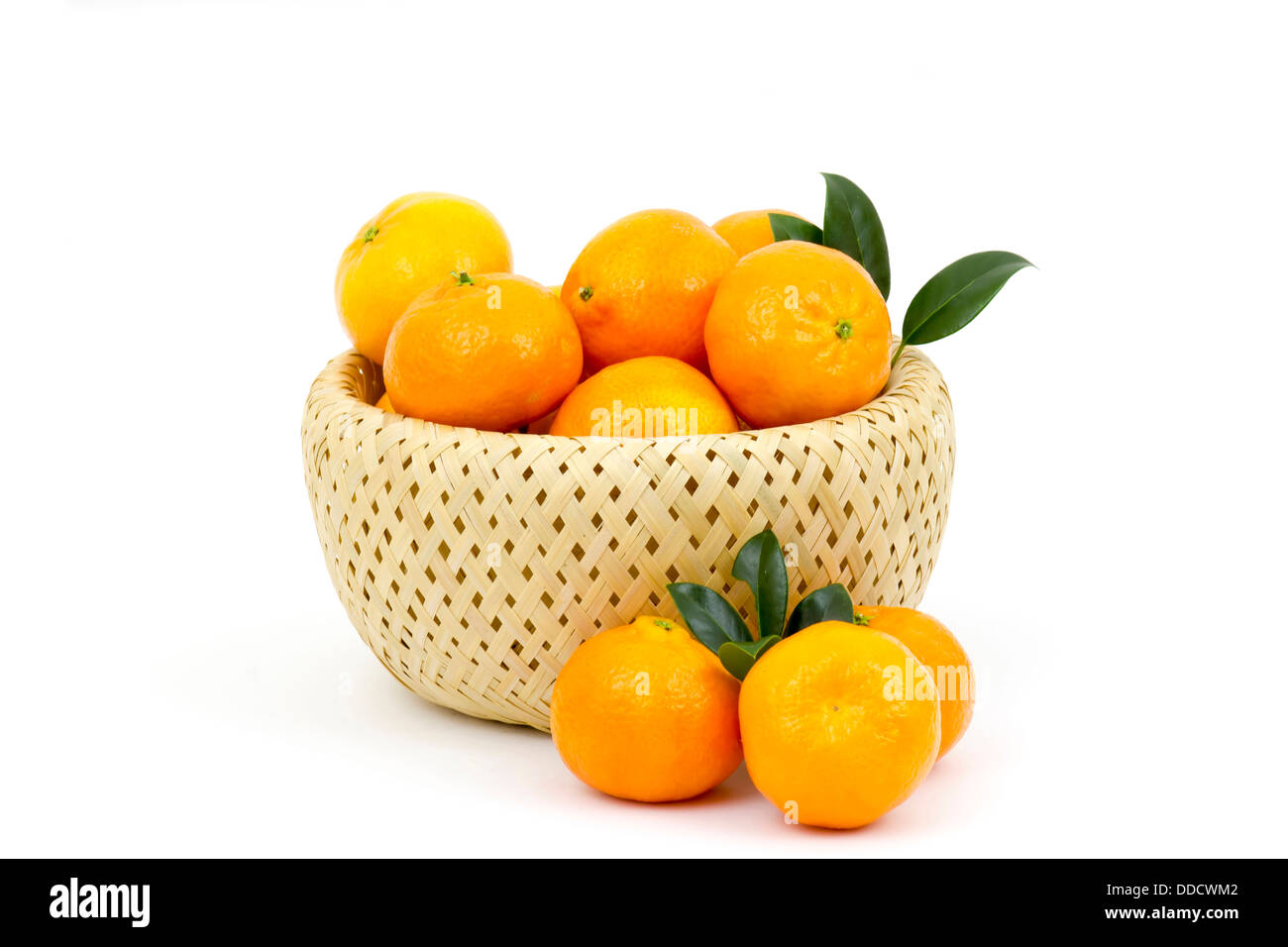 tangerines in a basket on white background Stock Photo - Alamy
