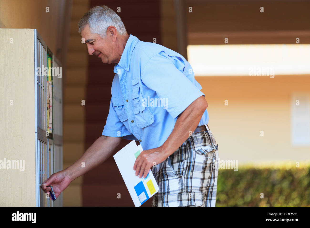 Senior man checking his mailbox Stock Photo - Alamy