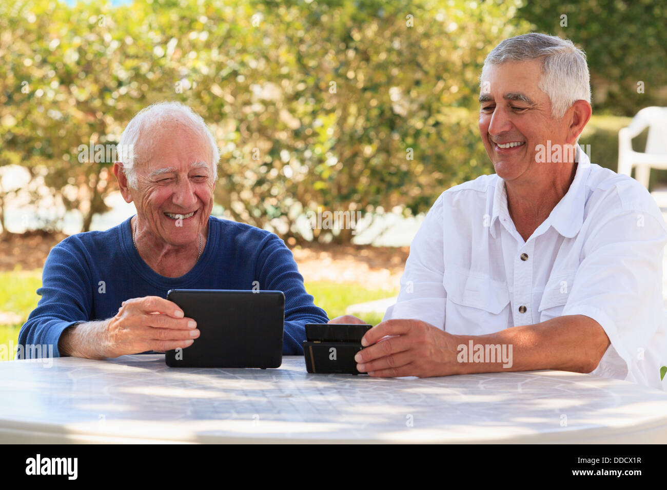 Family using electronic gadgets hi-res stock photography and images - Alamy