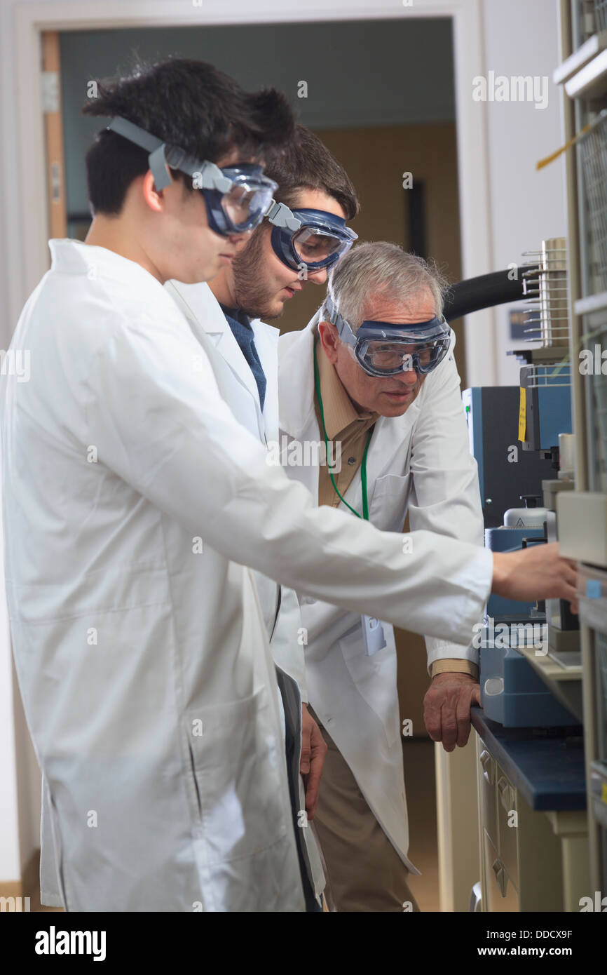 Professor working with engineering students on thermomechanical ...