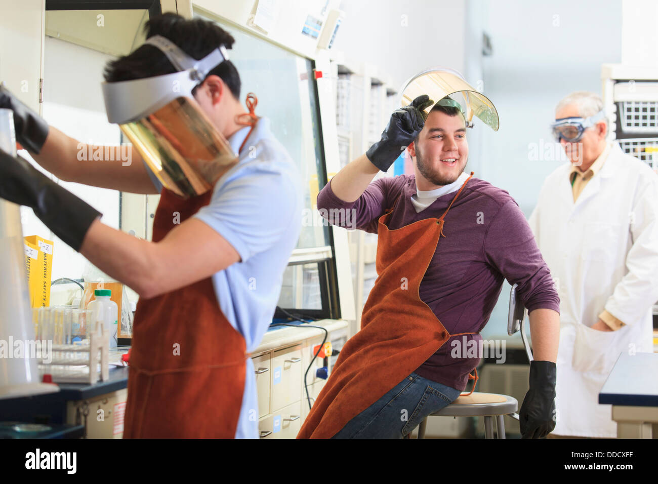 Engineering students and professor wearing protective equipment while ...