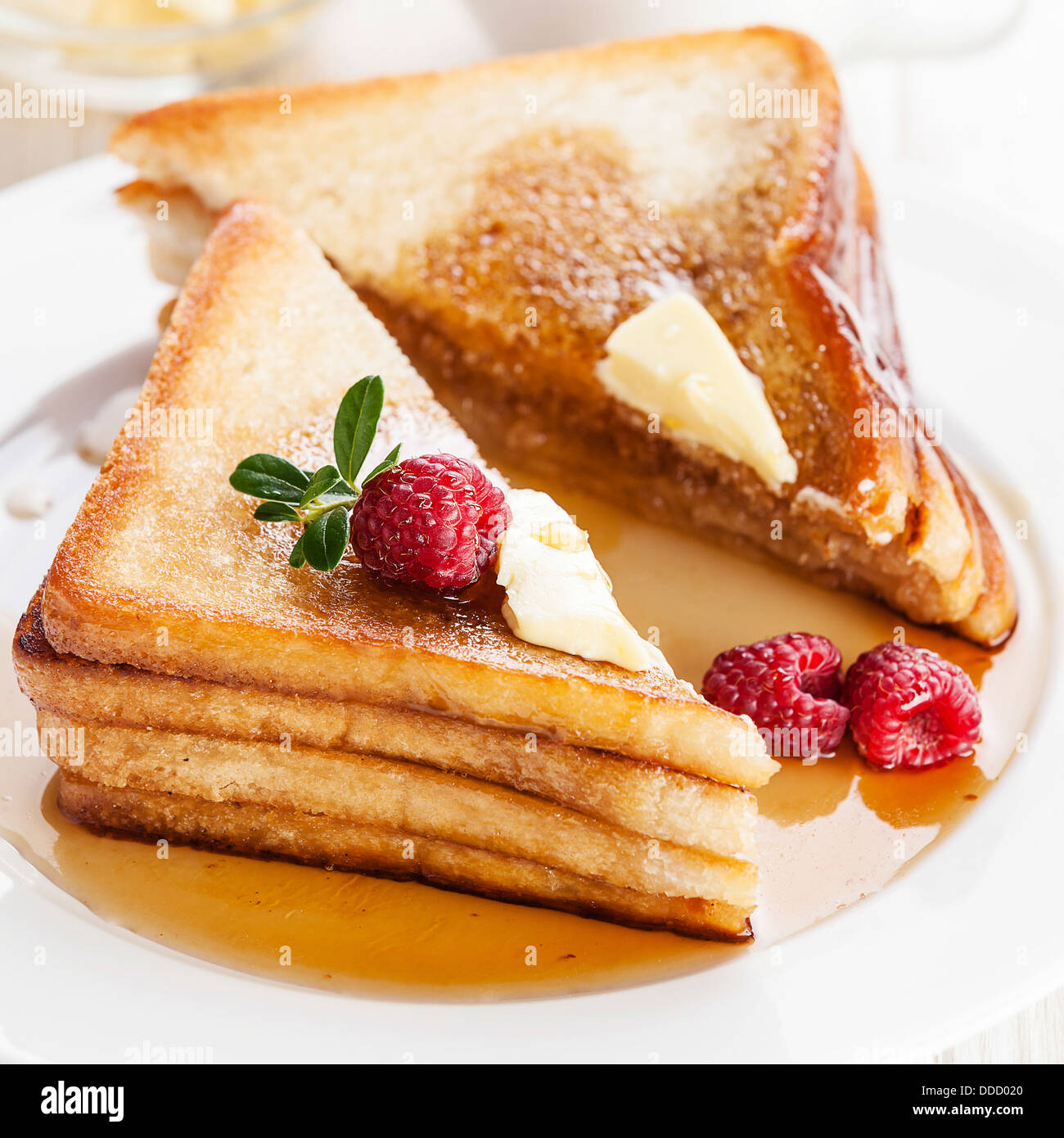 French toast with raspberries, maple syrup and butter Stock Photo - Alamy