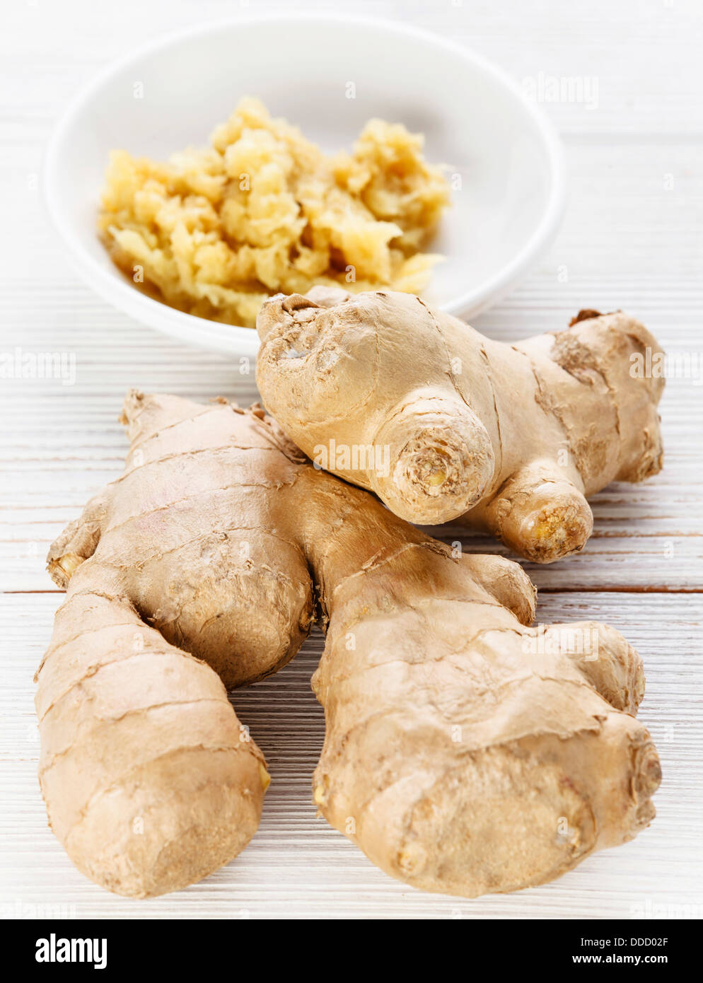 Raw ginger root spice on wooden table Stock Photo - Alamy