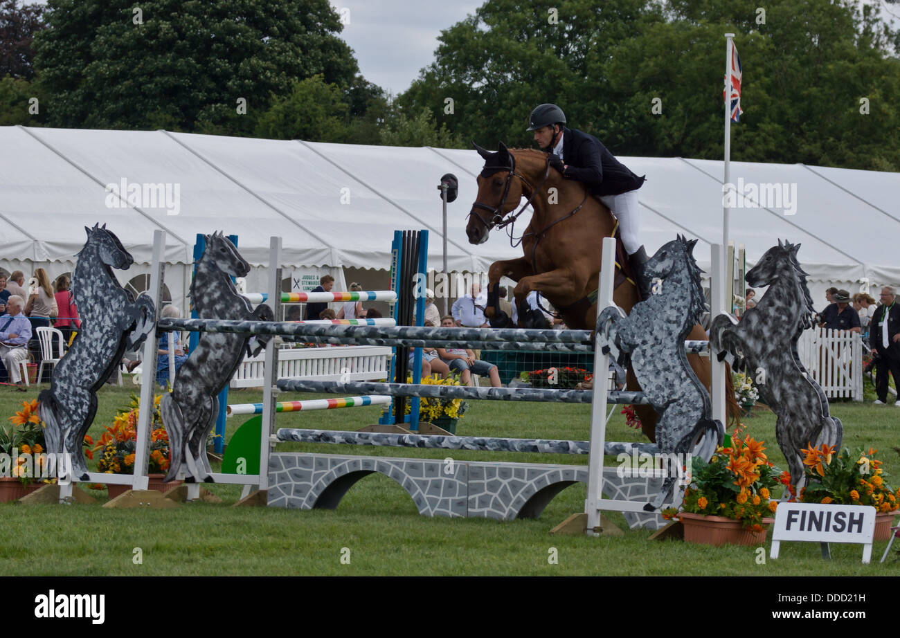 Equestrian horse show jumping at Weedon Buck's County show. A rider ...