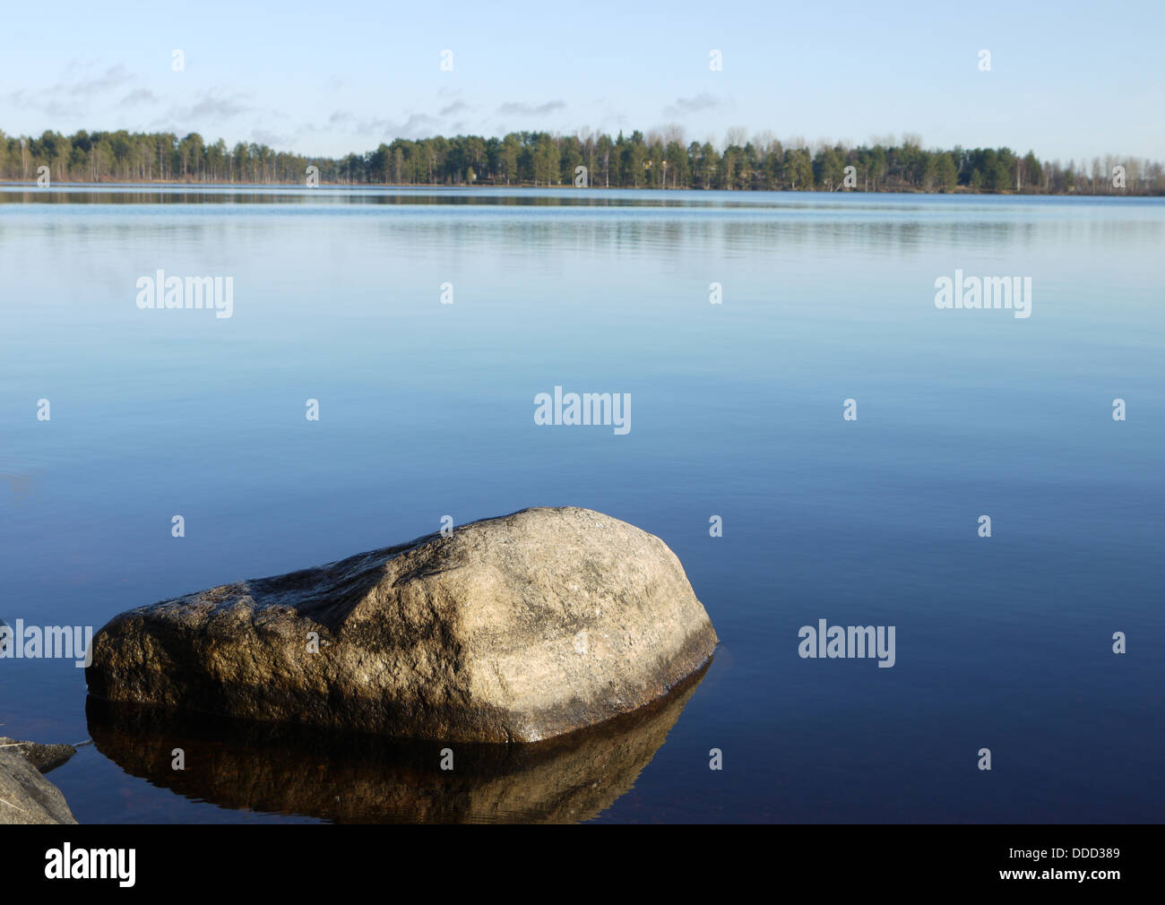 Stone in lake Stock Photo - Alamy