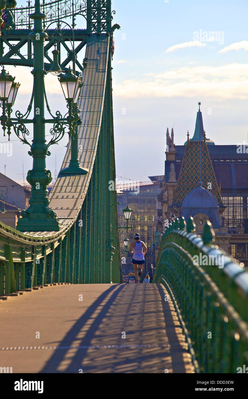 Jogger on Liberty Bridge, Gellert Hotel and Spa in Background, Budapest ...