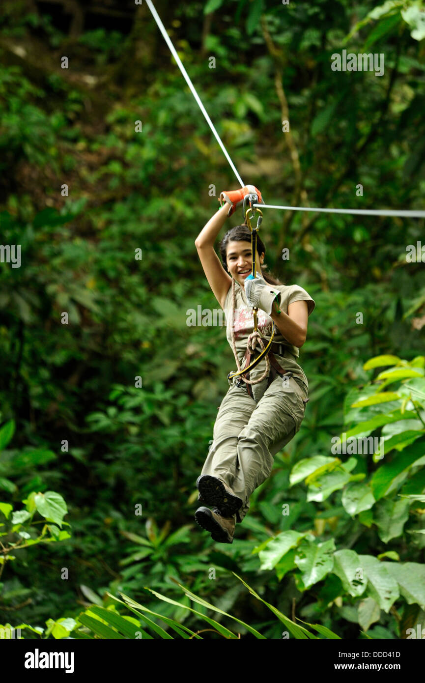 A woman swoops down a zip line Stock Photo - Alamy