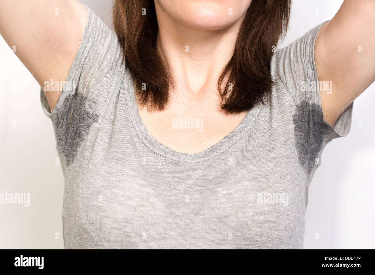 Woman sweating very badly under armpit and holding nose Stock Photo - Alamy