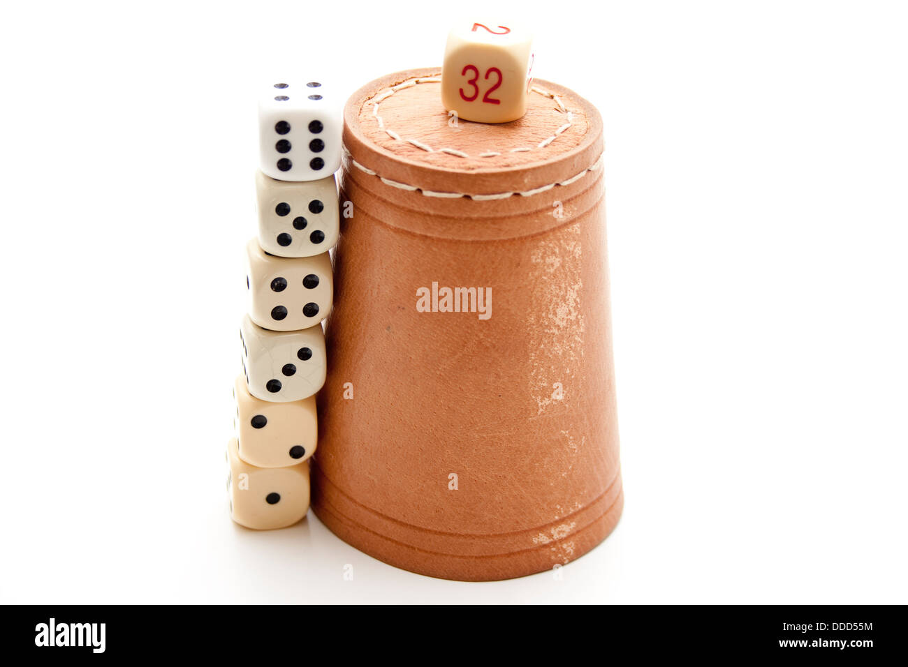 Dice cup with cube Stock Photo - Alamy