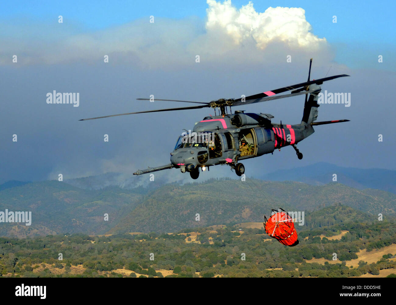 A California Air National Guards Black Hawk helicopter drops water on ...