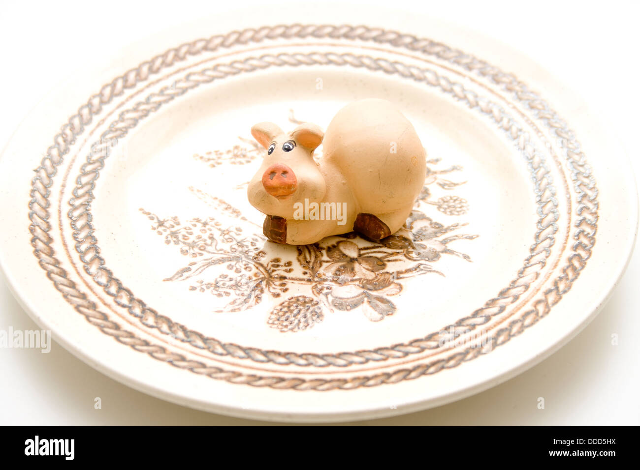 Ceramic pig on porcelain plate Stock Photo - Alamy