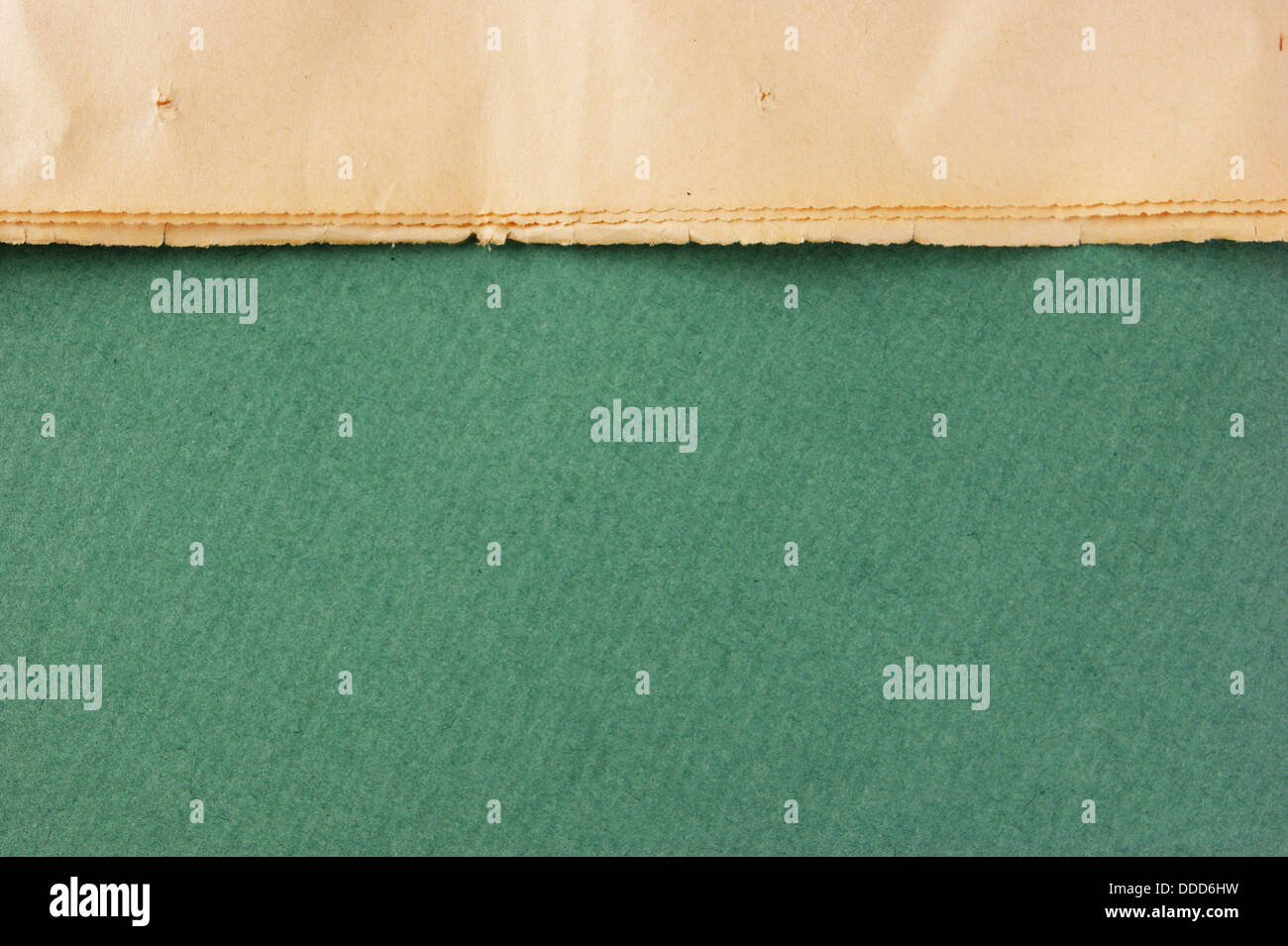 edge of the old newspaper on a green background Stock Photo - Alamy
