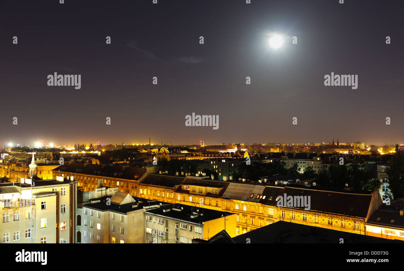 rooftops of old houses at night with the moon shining Stock Photo - Alamy