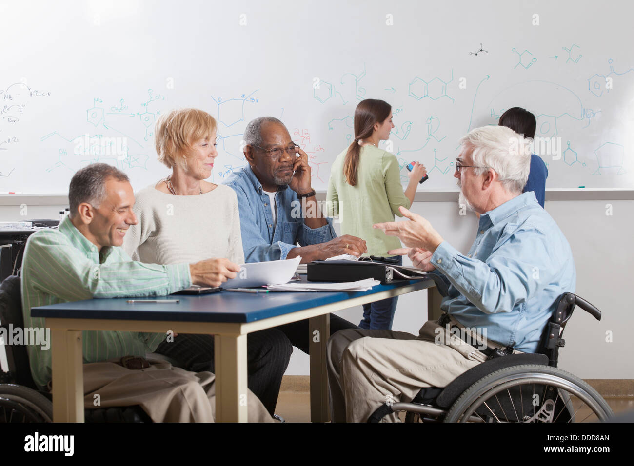 Faculty meeting in an engineering school, one professor with a spinal ...