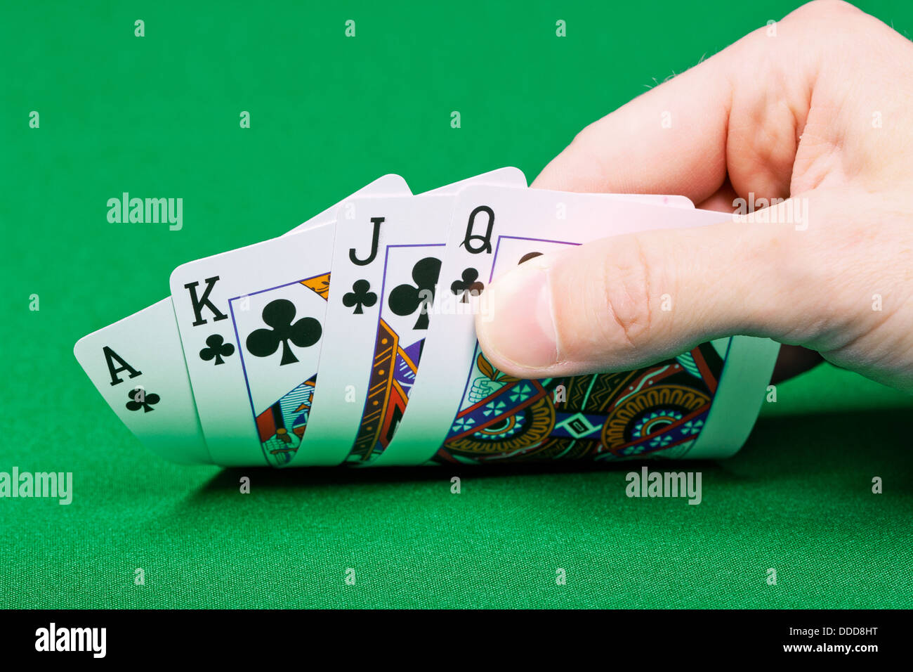 four cards in the player's hand on green table Stock Photo - Alamy