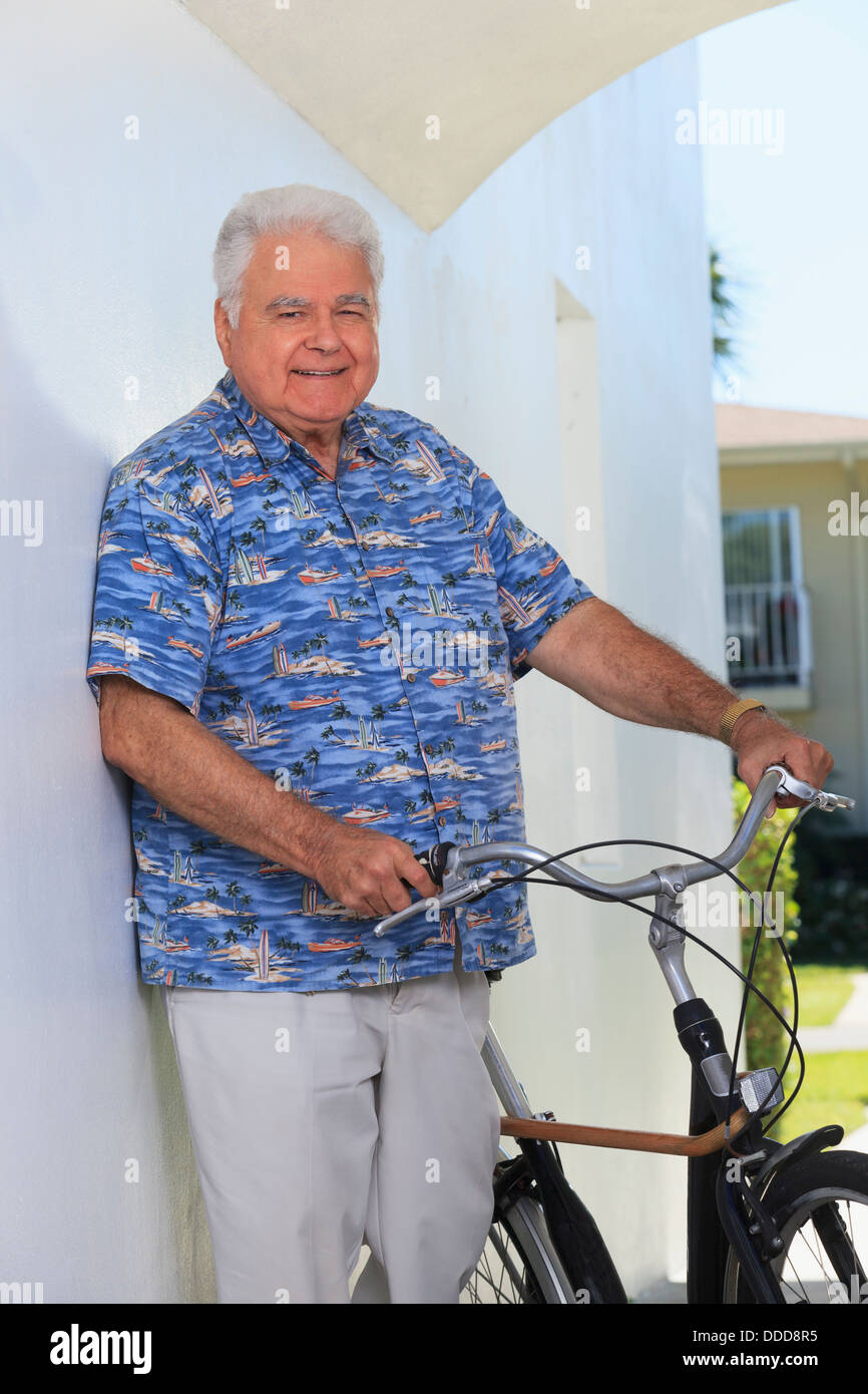 Senior man with polio holding a bicycle with cane attached Stock Photo ...