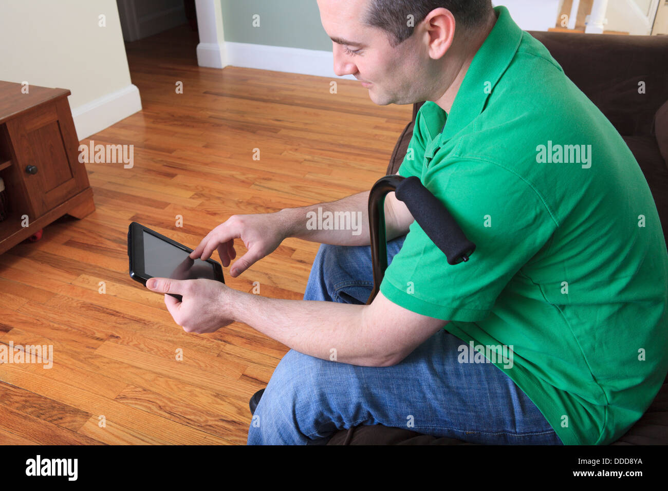 Man after anterior cruciate ligament (ACL) surgery with cane and using ...