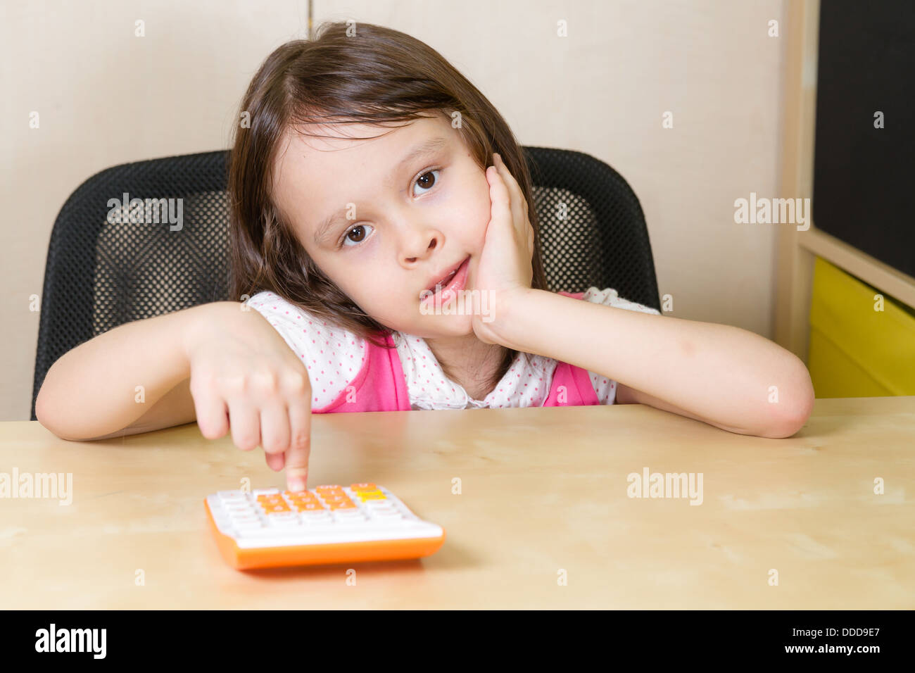 Child with calculator in corporate office Stock Photo - Alamy