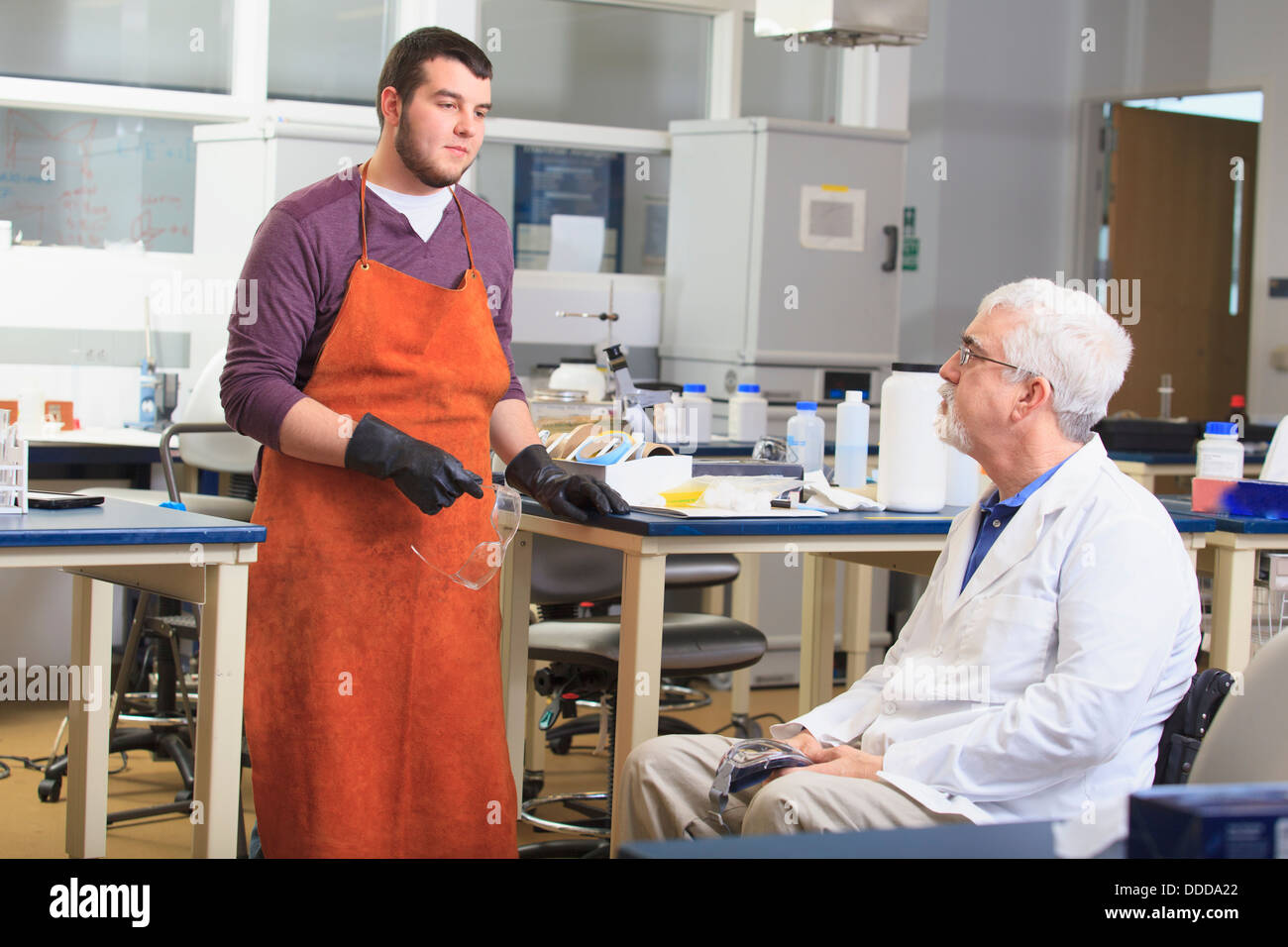 Professor with muscular dystrophy advising engineering student in a ...