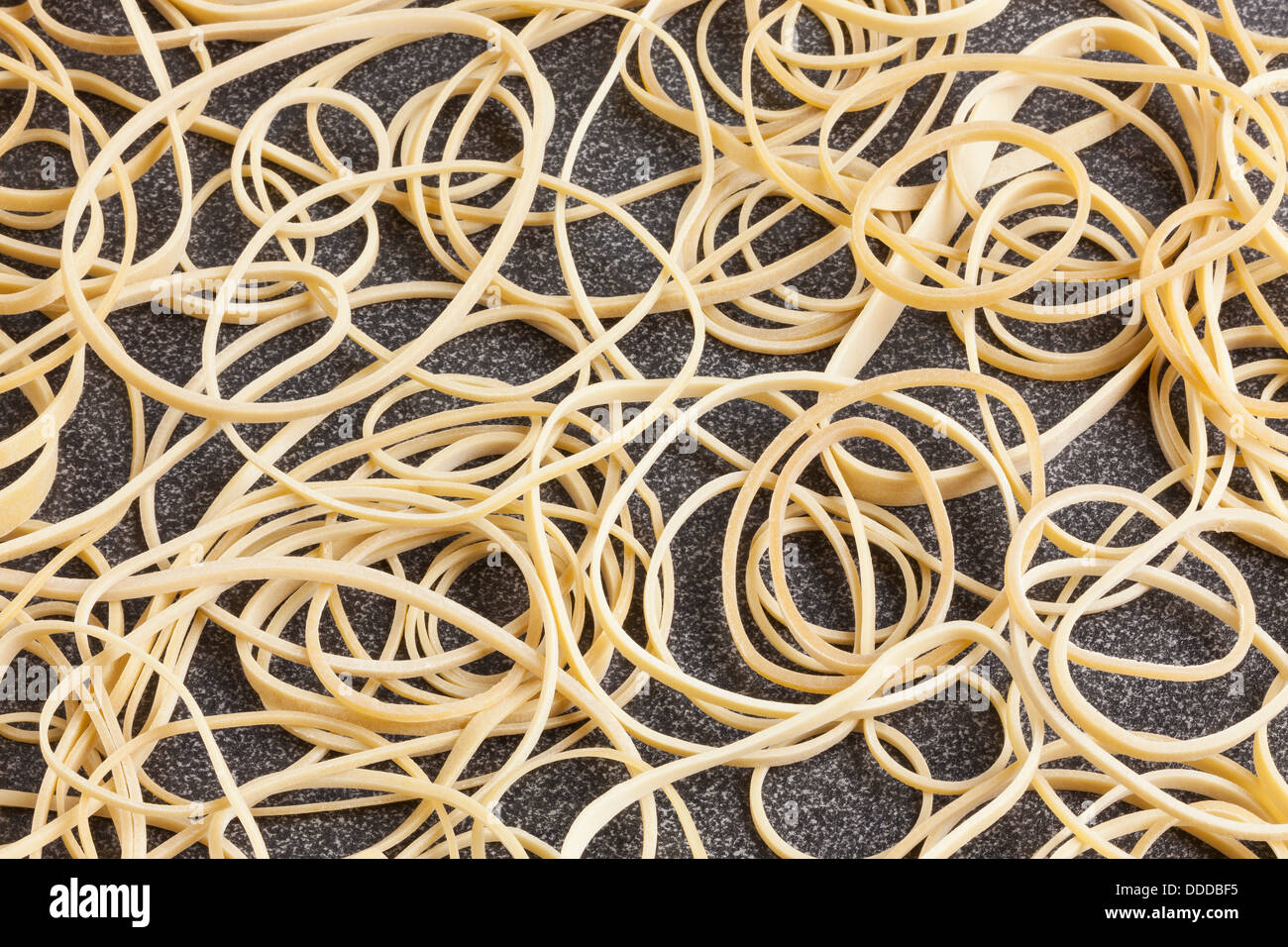 Close-up pile of rubber bands on desktop, studio shot Stock Photo - Alamy