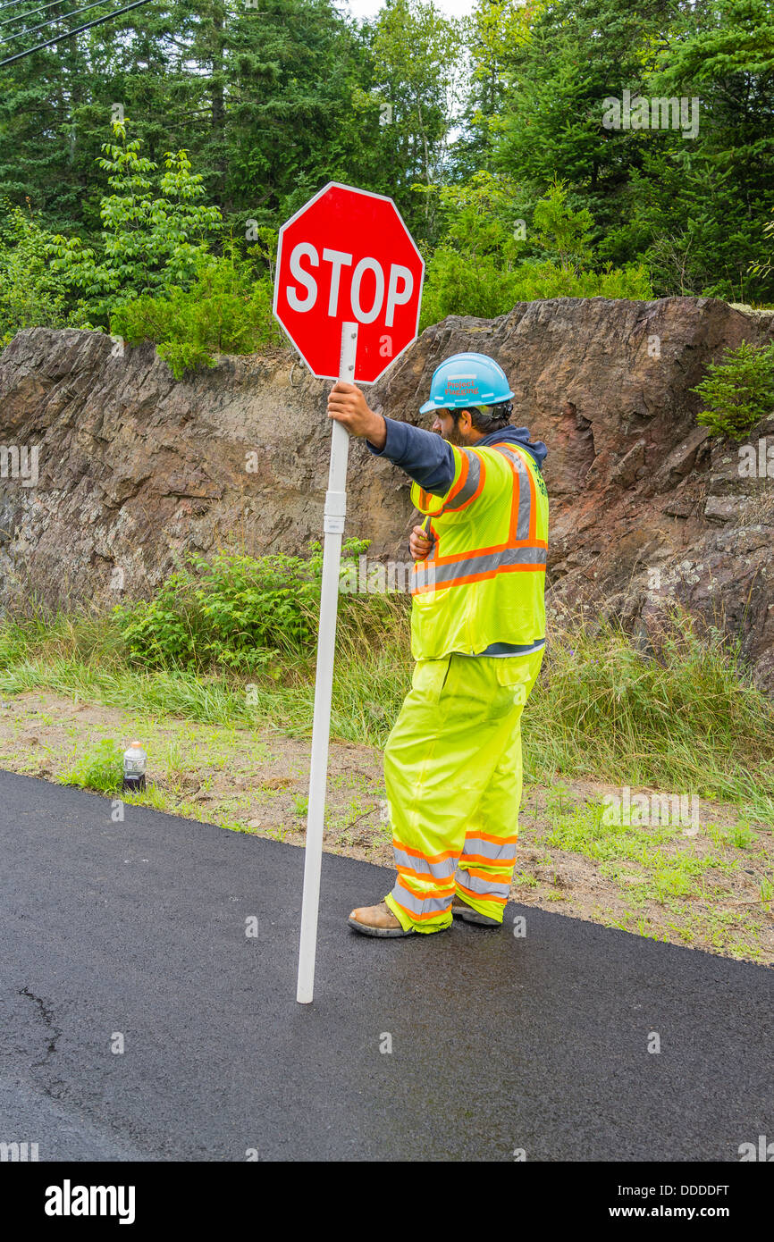 Road worker holding stop sign hi-res stock photography and images - Alamy