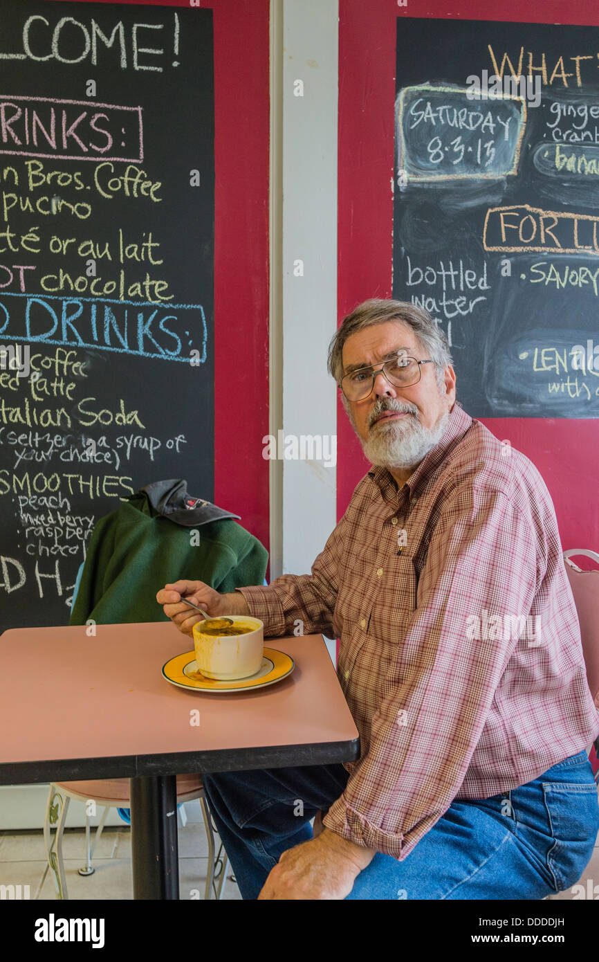 Older man sits table hi-res stock photography and images - Alamy