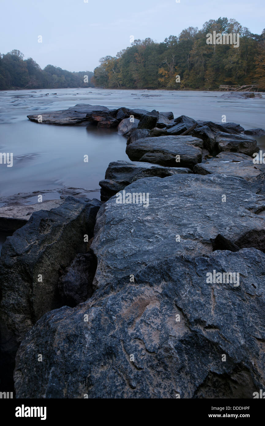 Rocky river bank at foggy morning Stock Photo - Alamy