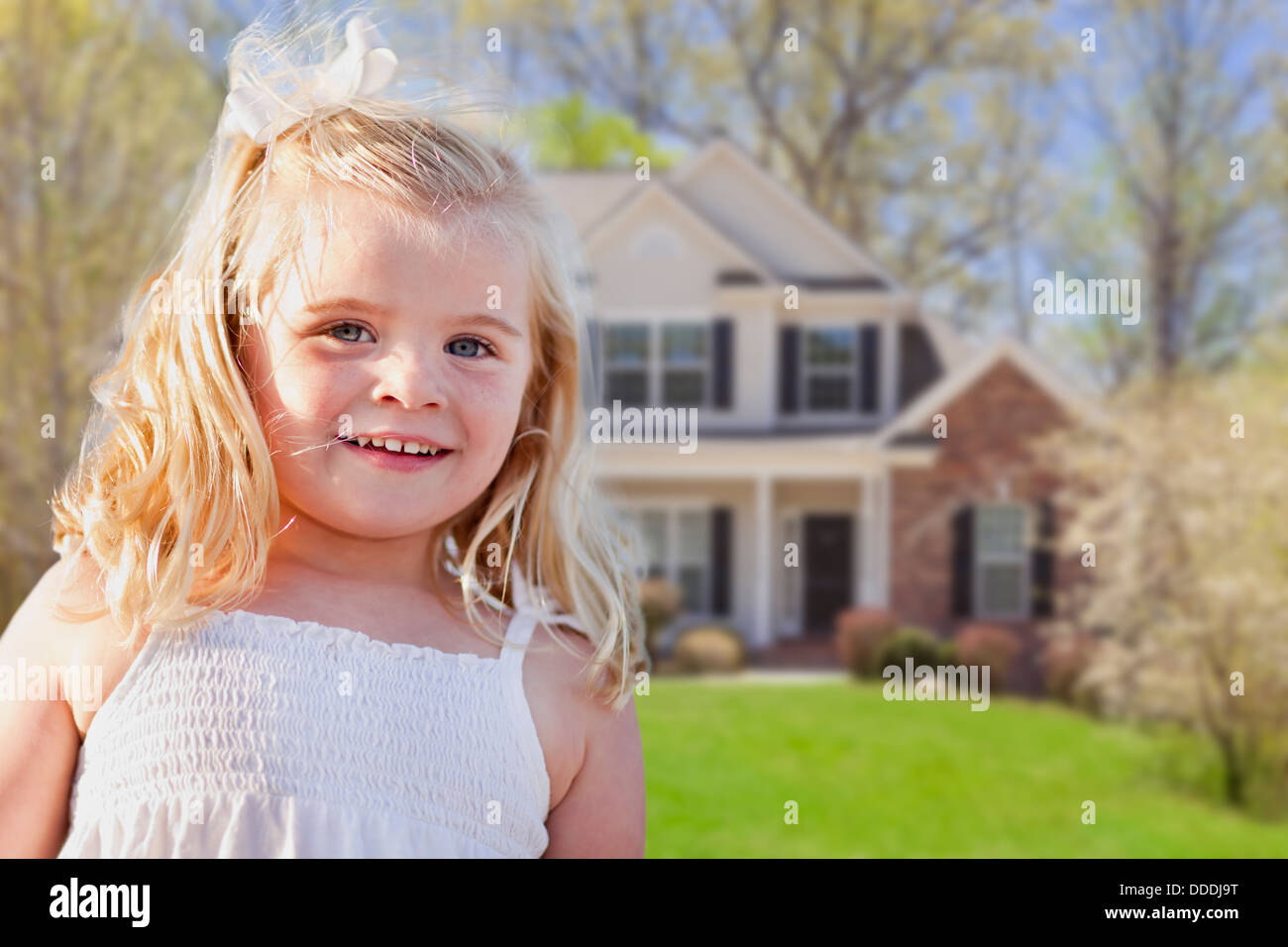 Cute Smiling Girl Playing in Front Yard of House Stock Photo - Alamy