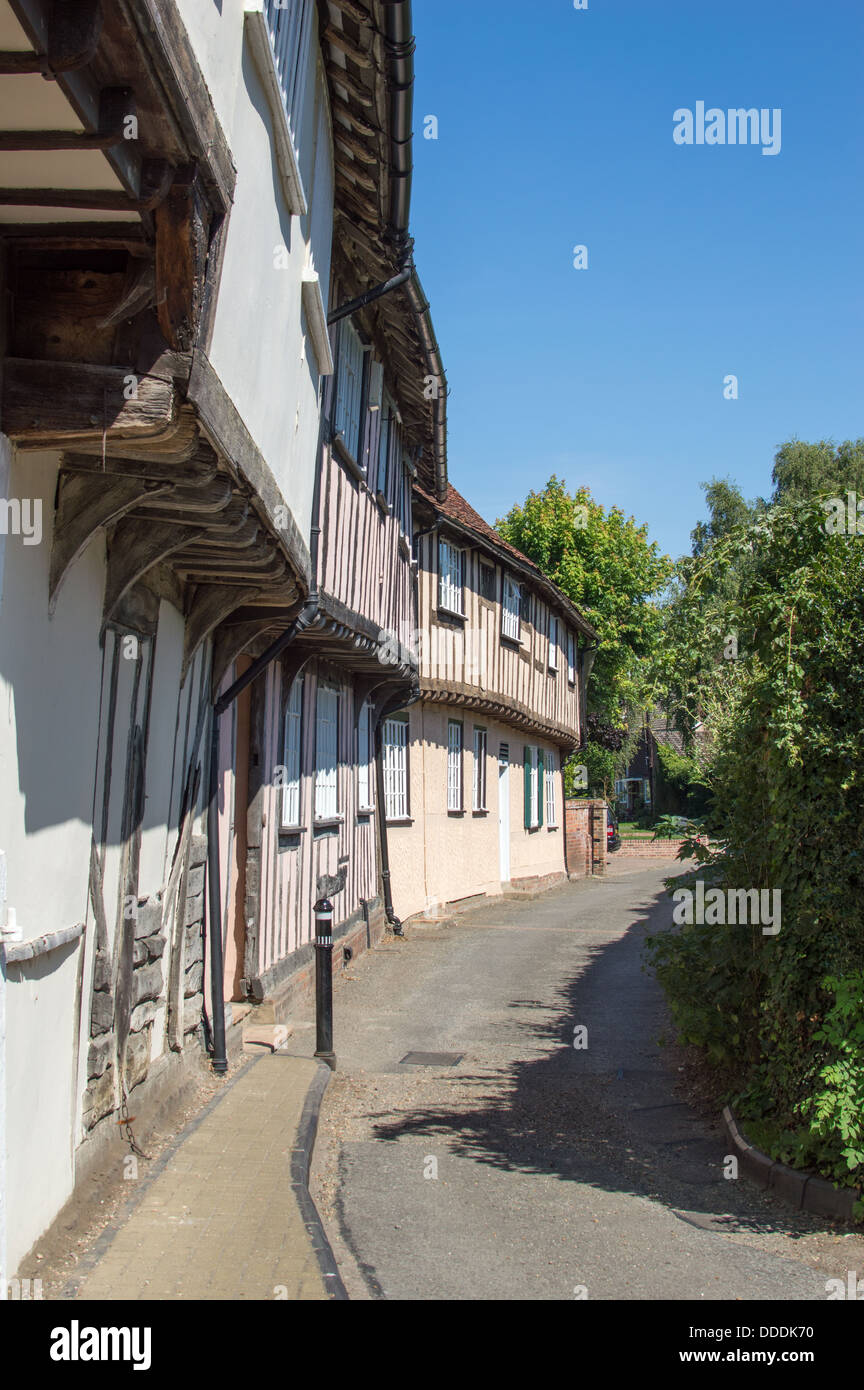 A narrow lane lined with medieval buildings with overhanging upper ...