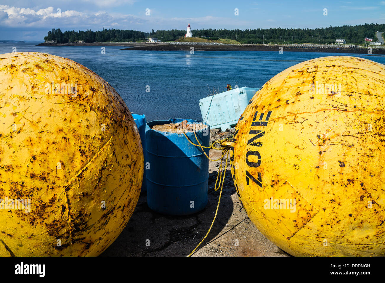 A view of the Lubec, Maine seashore with a large yellow metal float in ...