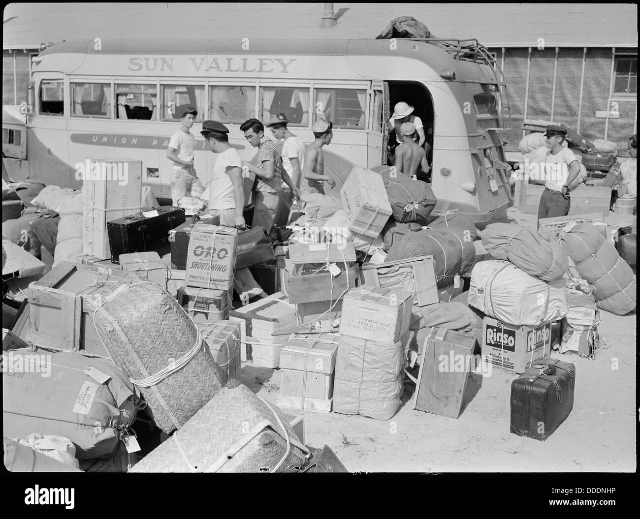 This image shows baggage belonging to evacuees from the assembly center ...