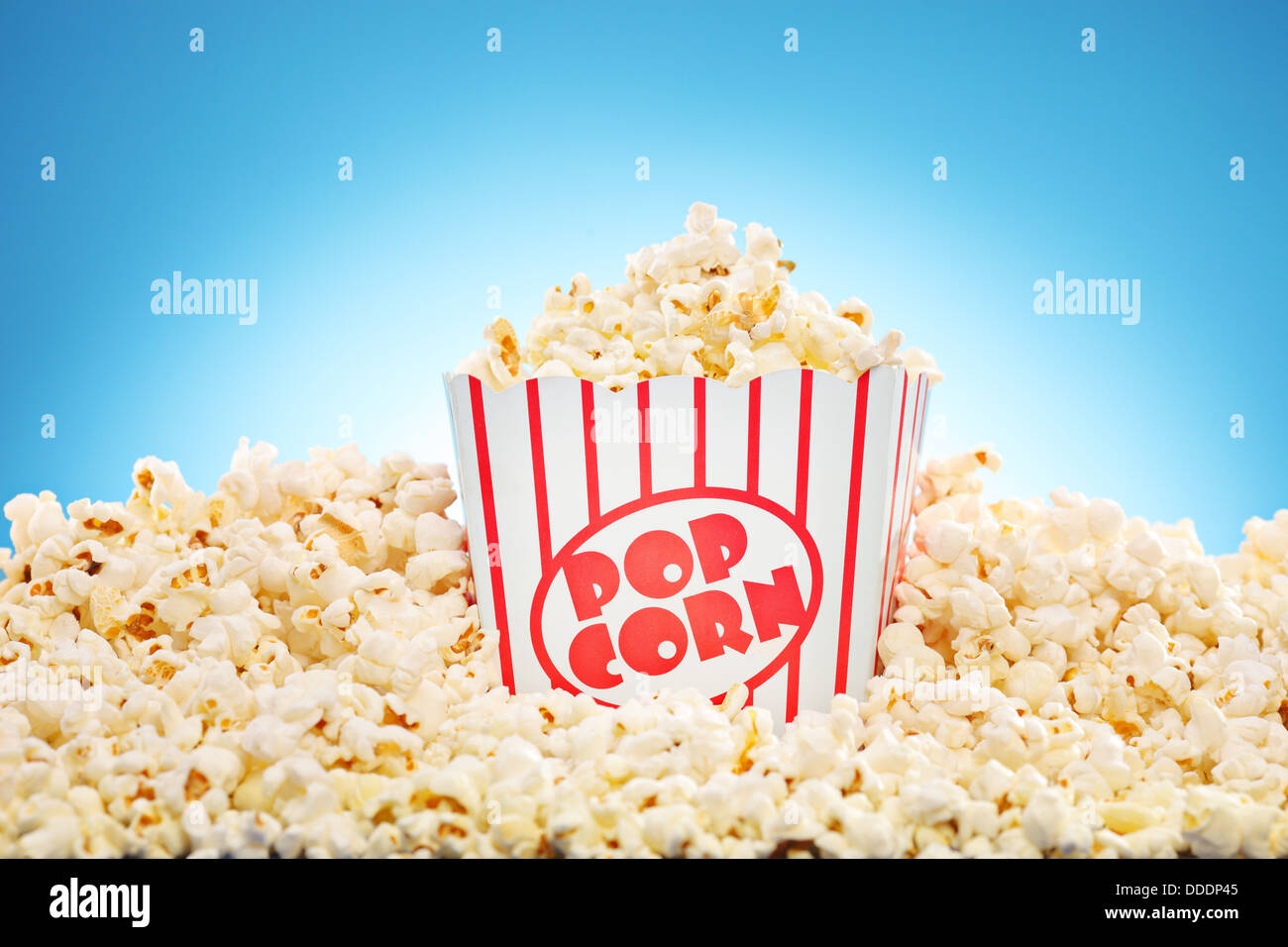 Popcorn in classic box overflowing with freshly popped corn Stock Photo ...