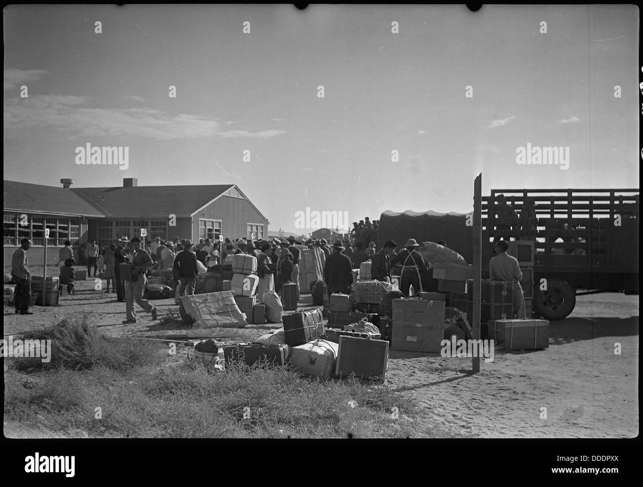 This photograph shows the loading of baggage at the Granada Relocation ...