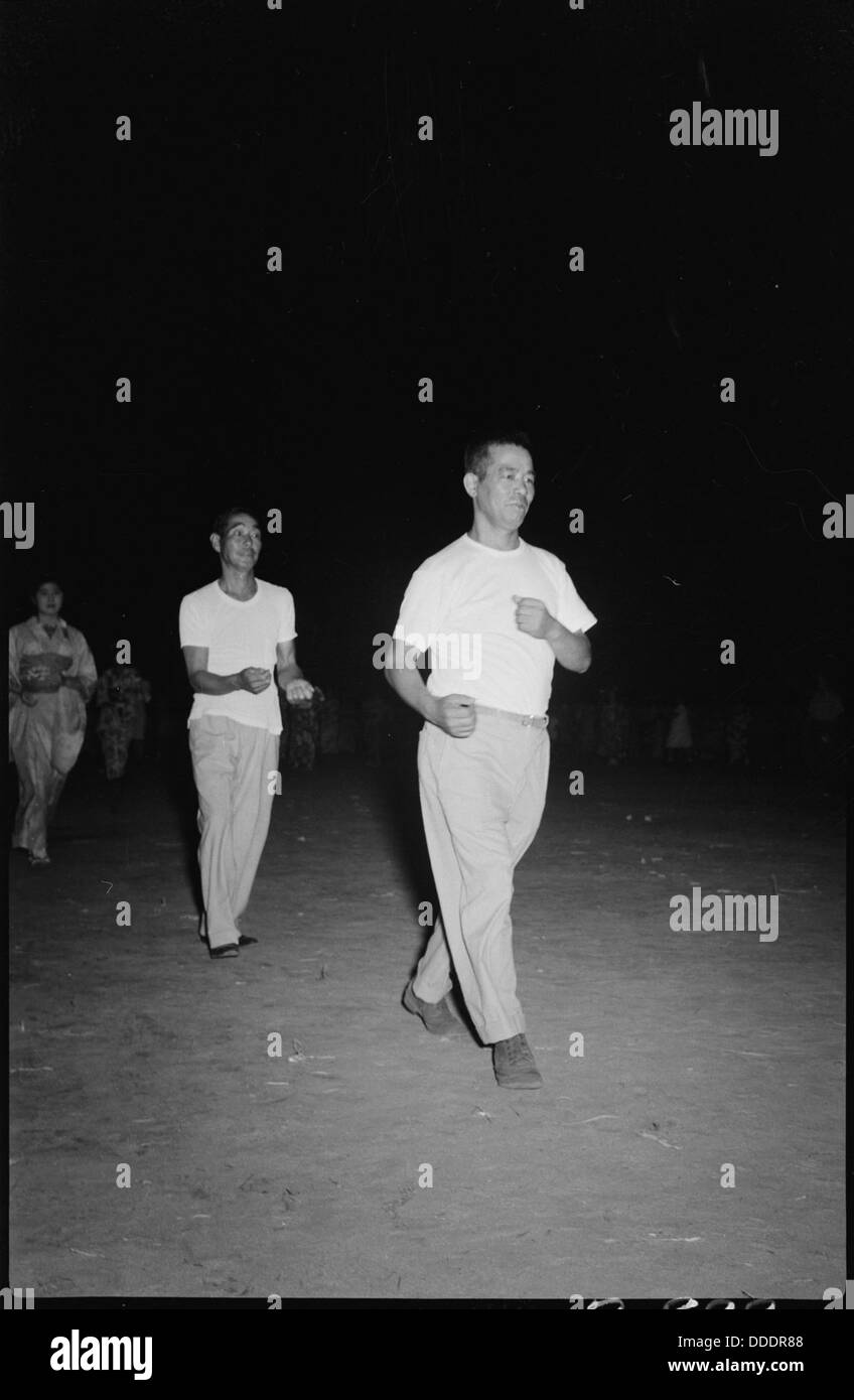 A photograph showing two Issei individuals participating in the Bon ...